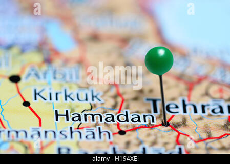 Close up to a Hamadan city with a green pin needle into Iran country ...