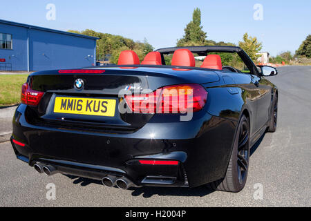 Red BMW convertible interior with black leather seats and dashboard at classic car show Stock ...