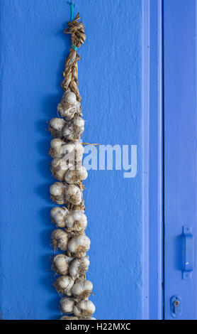 garlic braid hanging on wall of pattern tiles Stock Photo - Alamy