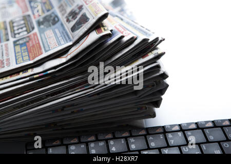 stack of newspapers and keyboard close-up Stock Photo - Alamy