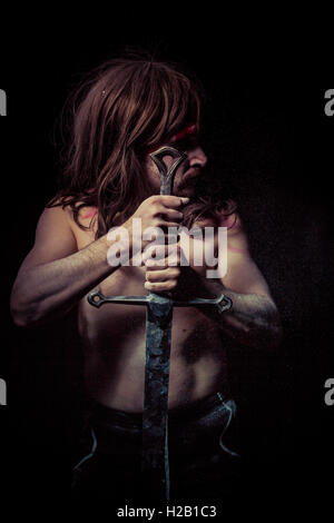 Medieval savage warrior with iron sword Stock Photo - Alamy
