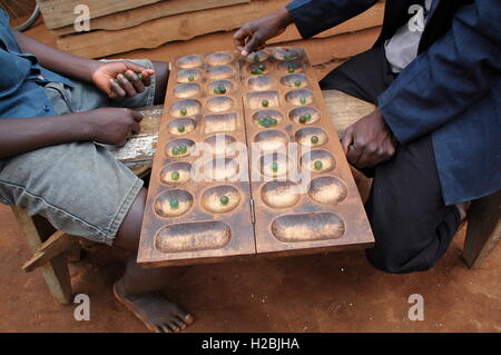 Mancala board with shells. Mancala is a traditional board game played ...