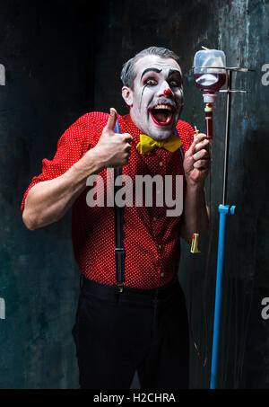 The scary clown and drip with blood on dack background. Halloween ...