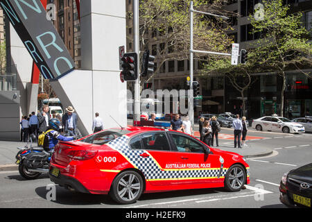 Australian Federal police,AFP, officers in a marked Holden police car ...