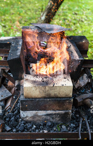 Close up of a heated iron rod on an anvil Stock Photo - Alamy