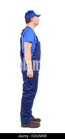 Worker in blue overalls. Side view Stock Photo - Alamy