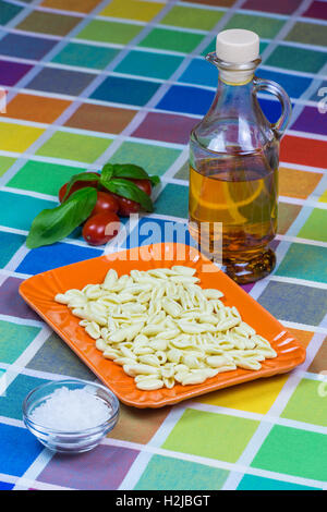 Uncooked fusilli pasta in ceramic bowl on white wooden background Stock ...