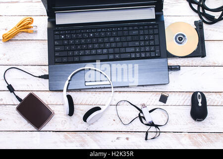 Computer peripherals and laptop accessories on white wooden background ...