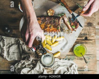 MAN EATING PORK MEAT Stock Photo - Alamy