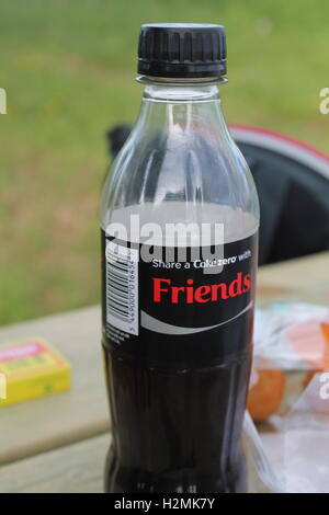 Half full Coca-Cola bottle Stock Photo - Alamy