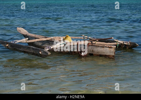 A Ngalawa or Ungalawa traditional, double-outrigger canoe used as a ...