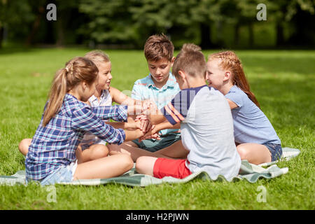 group of happy kids putting hands together Stock Photo - Alamy