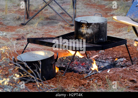 An Australian bush camp fire on rocks next to a creek burning in the ...