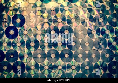 Old discs cd on wall with with multicolored colorful reflections ...