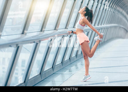 young fitness woman runner stretching legs before run Stock Photo - Alamy