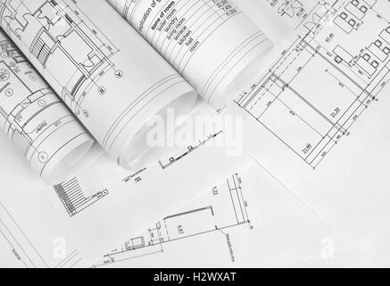 rolled architectural plans and technical drawings on house blueprint ...