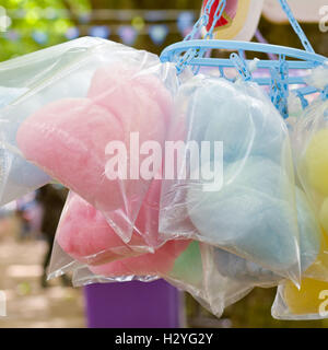 candy floss in bags hanging from a stall at a fairground Stock Photo ...