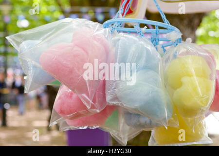candy floss in bags hanging from a stall at a fairground Stock Photo ...