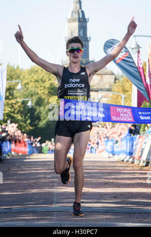Scottish runner Callum Hawkins crosses the finishing line to win the ...