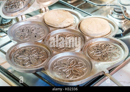 cooking Tigelle special pan Tigelliera, traditional food Bologna Modena ...