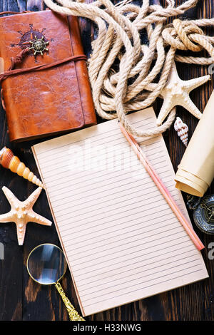 Shells and notepad on wooden table. Top view with copy space Stock ...