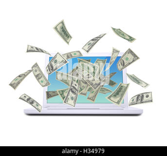 Dollar notes flying around the laptop Stock Photo - Alamy