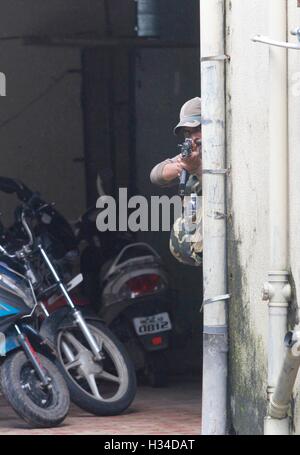A Force One commando conducts a search and combing operation in a slum ...