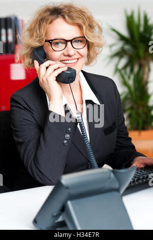 Charming businesswoman attending client's call Stock Photo - Alamy