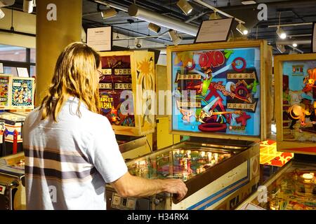 Young man enjoying a game at the Pinball Museum, Center in the Square ...
