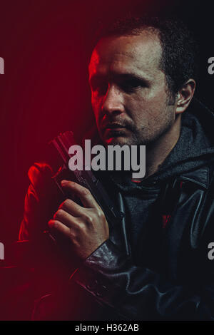 Robber with gun over red background Stock Photo - Alamy