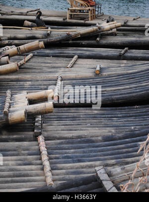 Man on bamboo float in shallow lagoon with panoramic view of shallow ...