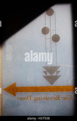 orange directional sign or arrows pointing two directions on a pole on ...