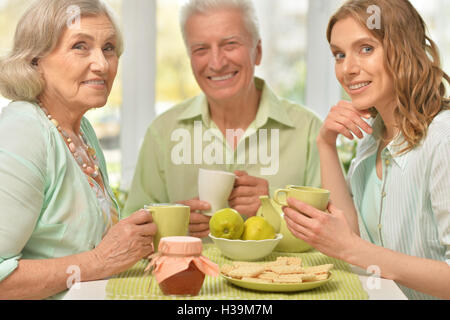 Daughter with senior parents drinking tea Stock Photo - Alamy