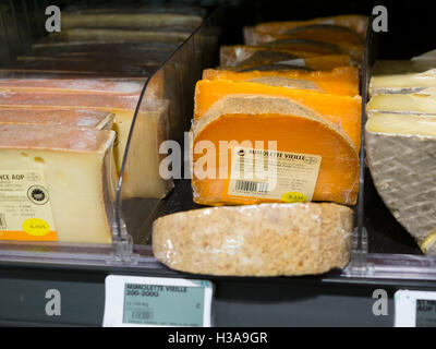 Wedge of orange French Mimolette cheese isolated on white background ...