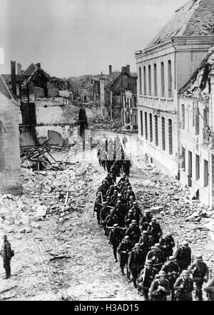 German soldiers marching through the town of Storkow, Germany. Ca. 1943 ...