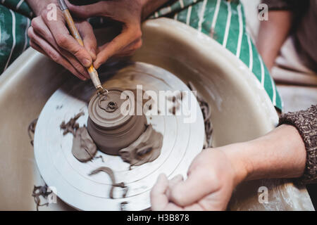 Cropped image of potters working Stock Photo - Alamy