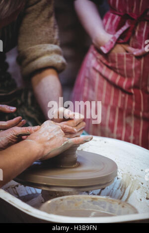Cropped image of potters working Stock Photo - Alamy