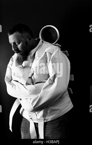Insane man in strait-jacket screaming in isolation Stock Photo - Alamy