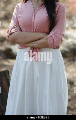 ethnic woman standing with arms folded Stock Photo - Alamy