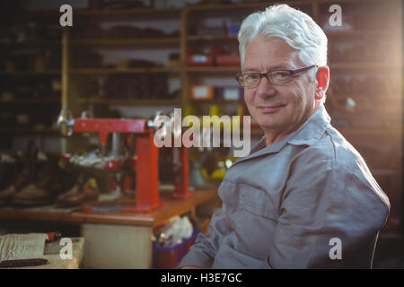 Portrait of shoemaker sitting in workshop Stock Photo - Alamy