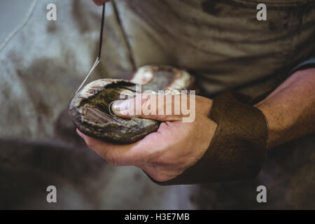 Shoemaker stitching shoe sole with needle Stock Photo - Alamy