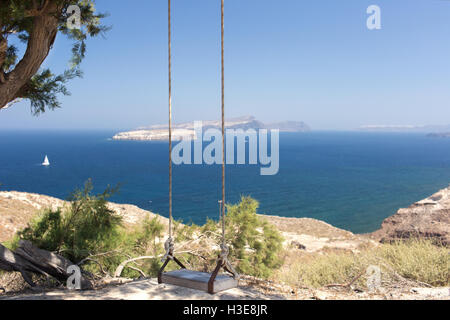Swing over the precipice on the sea background Stock Photo - Alamy