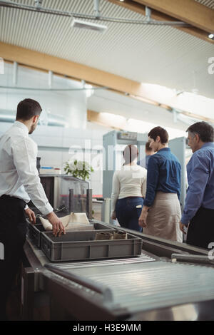 Female security guard walking through an automated revolving curved ...