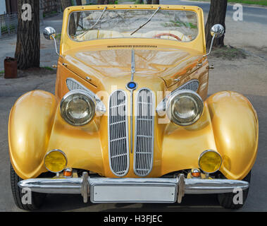 Old and stylish yellow collectible ancient car Stock Photo - Alamy