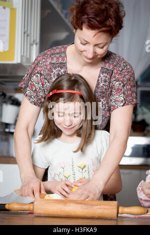 Child helping mother bake cookies Stock Photo - Alamy