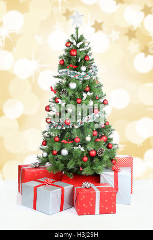 Christmas tree in snow with golden snowflakes on light blue background ...