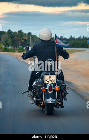 Man on Harley Davidson riding through US small town Stock Photo - Alamy