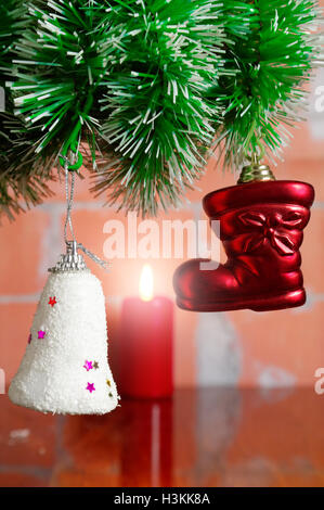 christmas baubles, burning candle and green pine fir prepared for ...