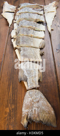 Wooden board with raw cut codfish on white background Stock Photo - Alamy