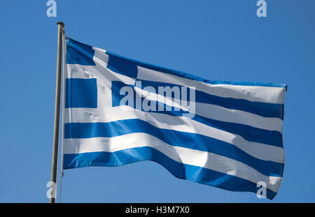 Greek flag on a flagpole against the blue sky Stock Photo - Alamy